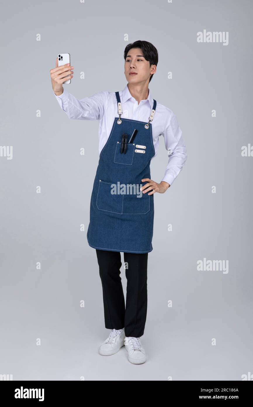 millennials and gen z, korean asian young man holding a smartphone ...