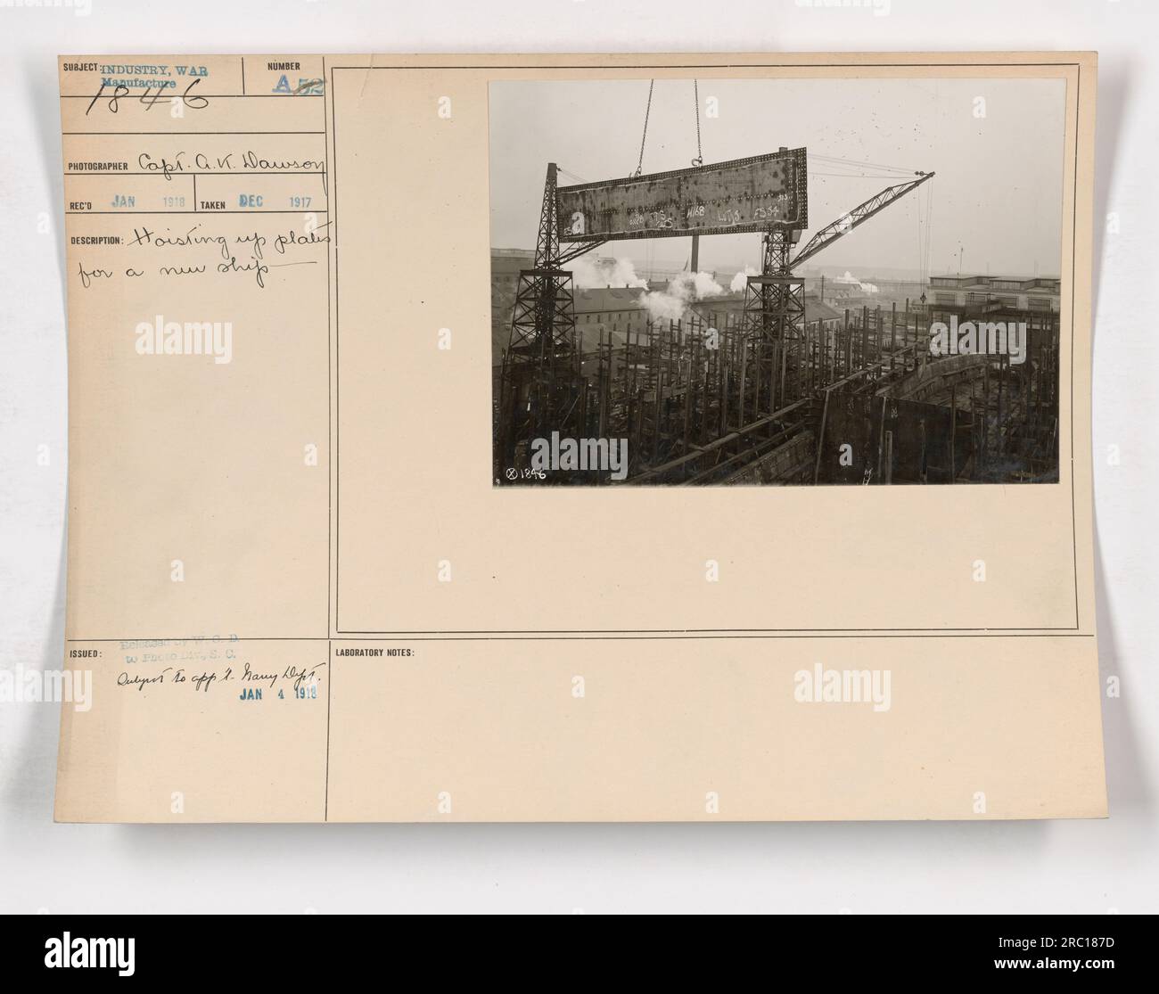 Workers hoist steel plates for a new ship during World War One. This ...