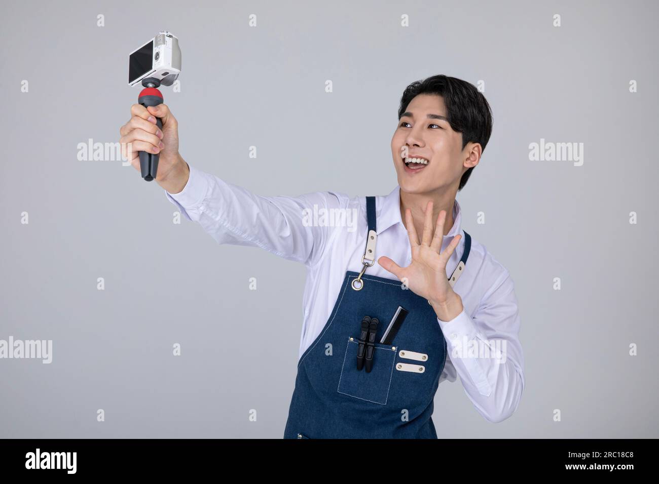 millennials and gen z, korean asian young man filming with a camera ...