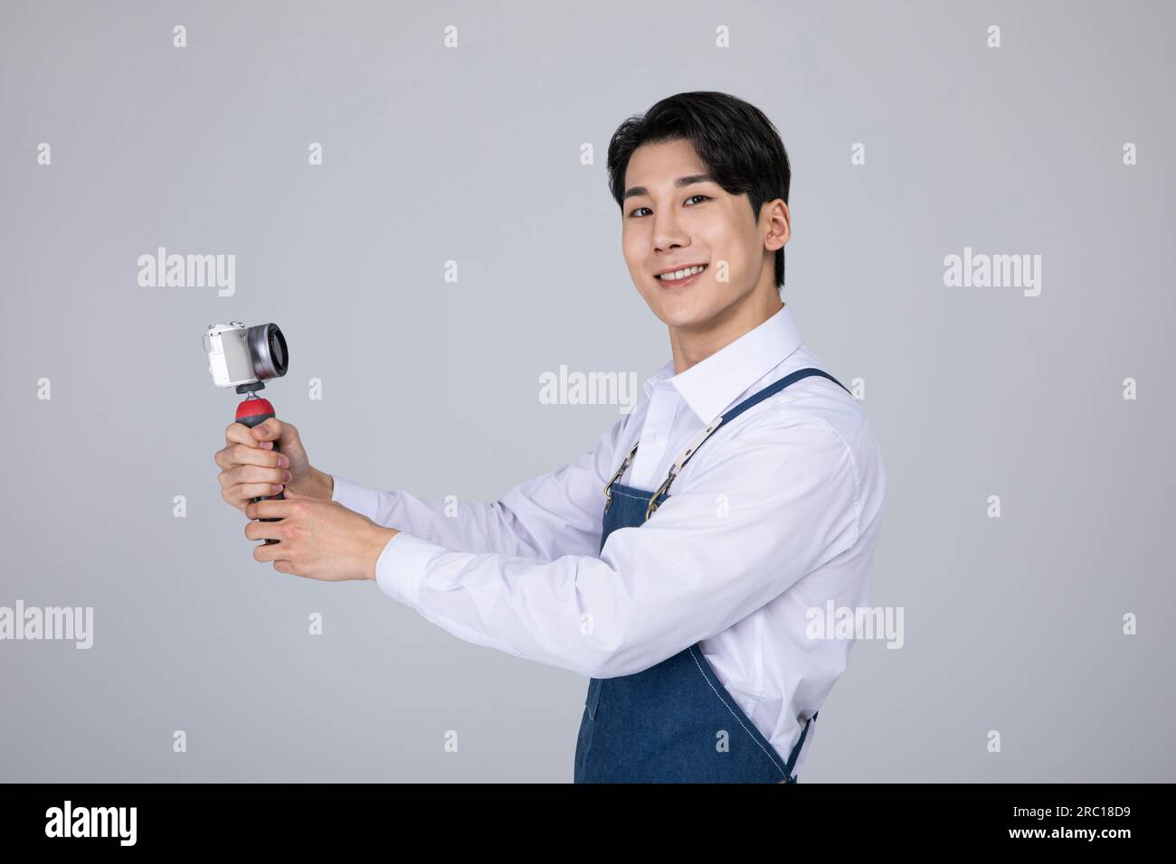 millennials and gen z, korean asian young man filming with a camera ...