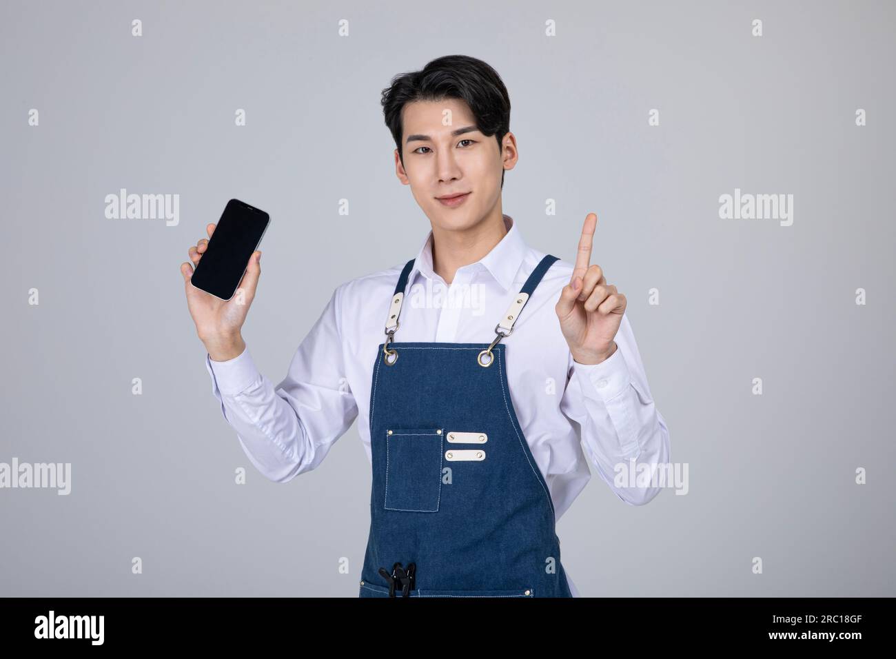 millennials and gen z, korean asian young man holding a smartphone ...