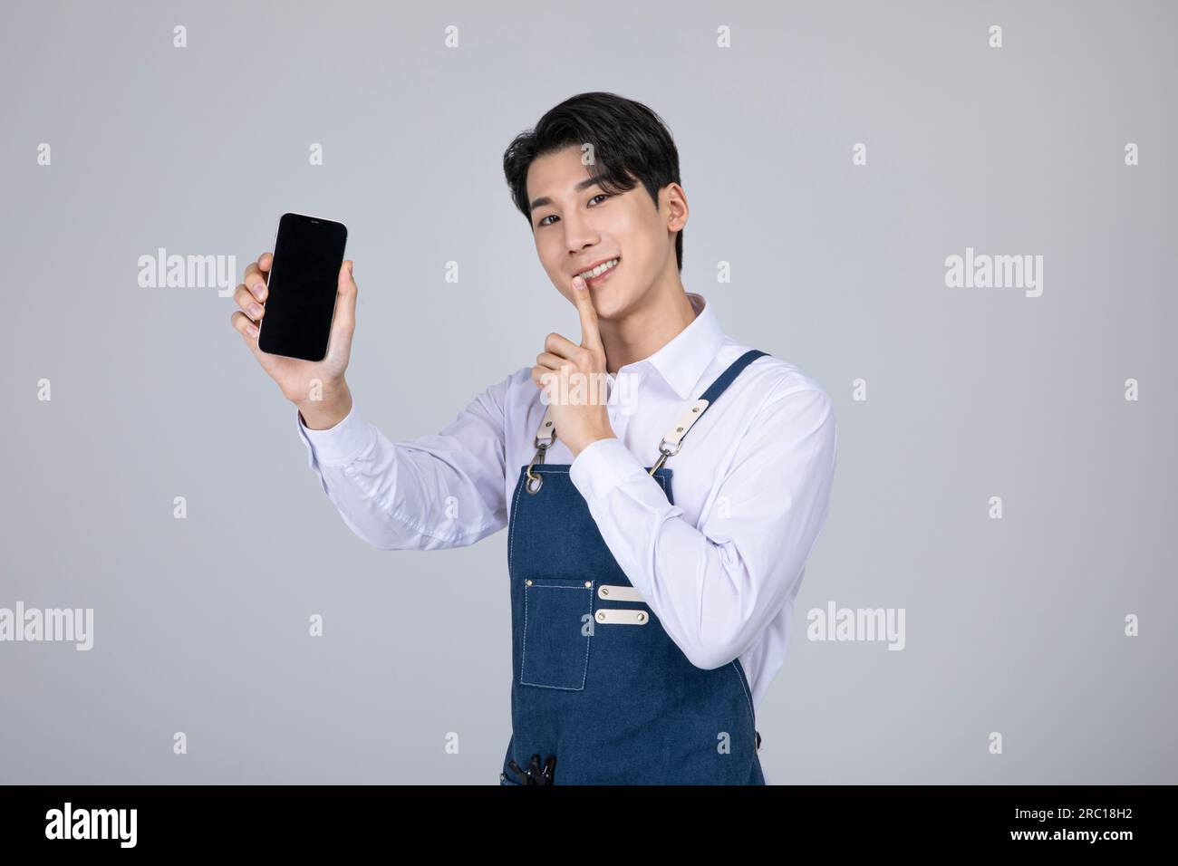 millennials and gen z, korean asian young man holding a smartphone ...
