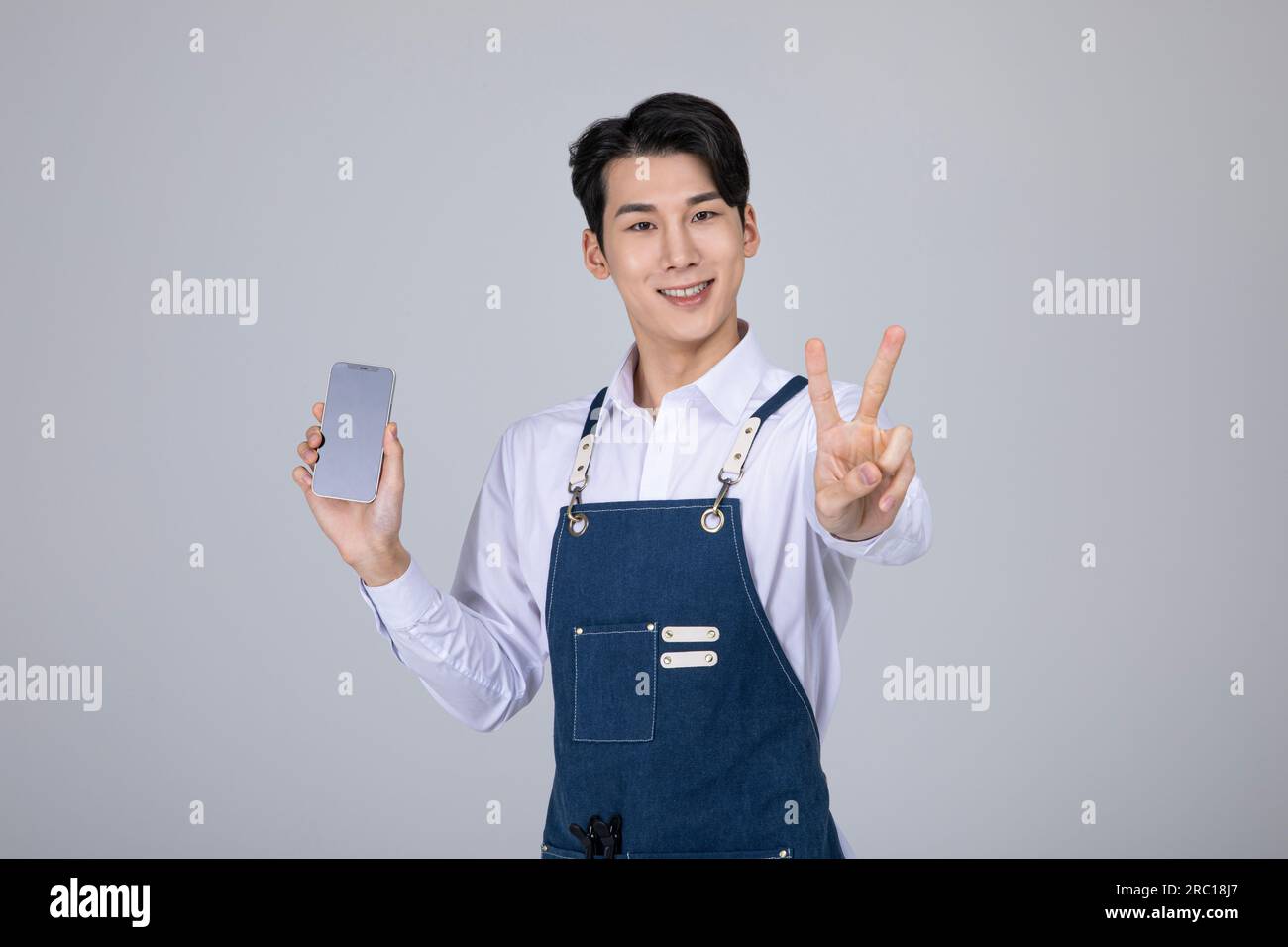 millennials and gen z, korean asian young man holding a smartphone ...