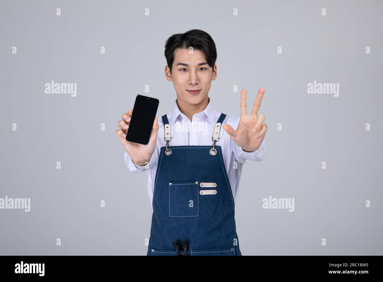 millennials and gen z, korean asian young man holding a smartphone ...