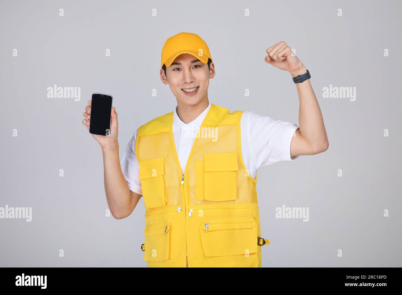 millennials and gen z, korean asian young man holding a smartphone with ...