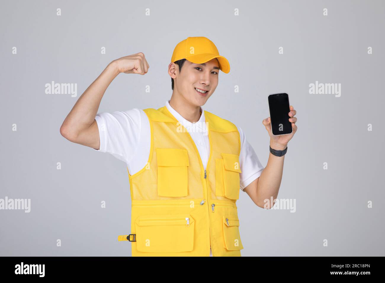 millennials and gen z, korean asian young man holding a smartphone with ...