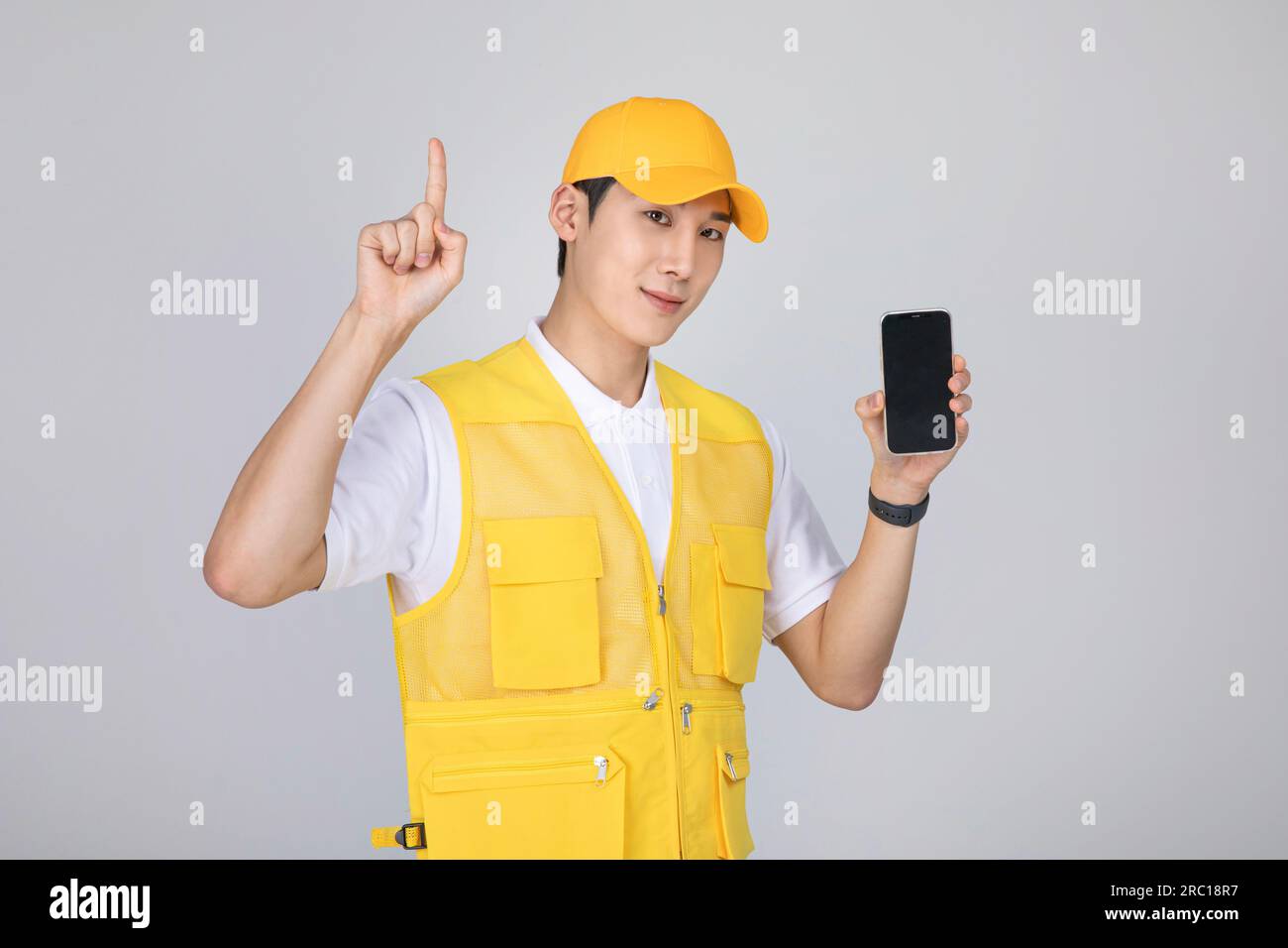 millennials and gen z, korean asian young man holding a smartphone with ...