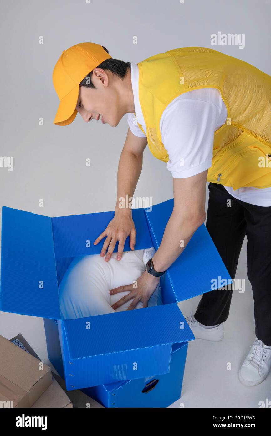 millennials and gen z, korean asian young man organizing moving boxes ...