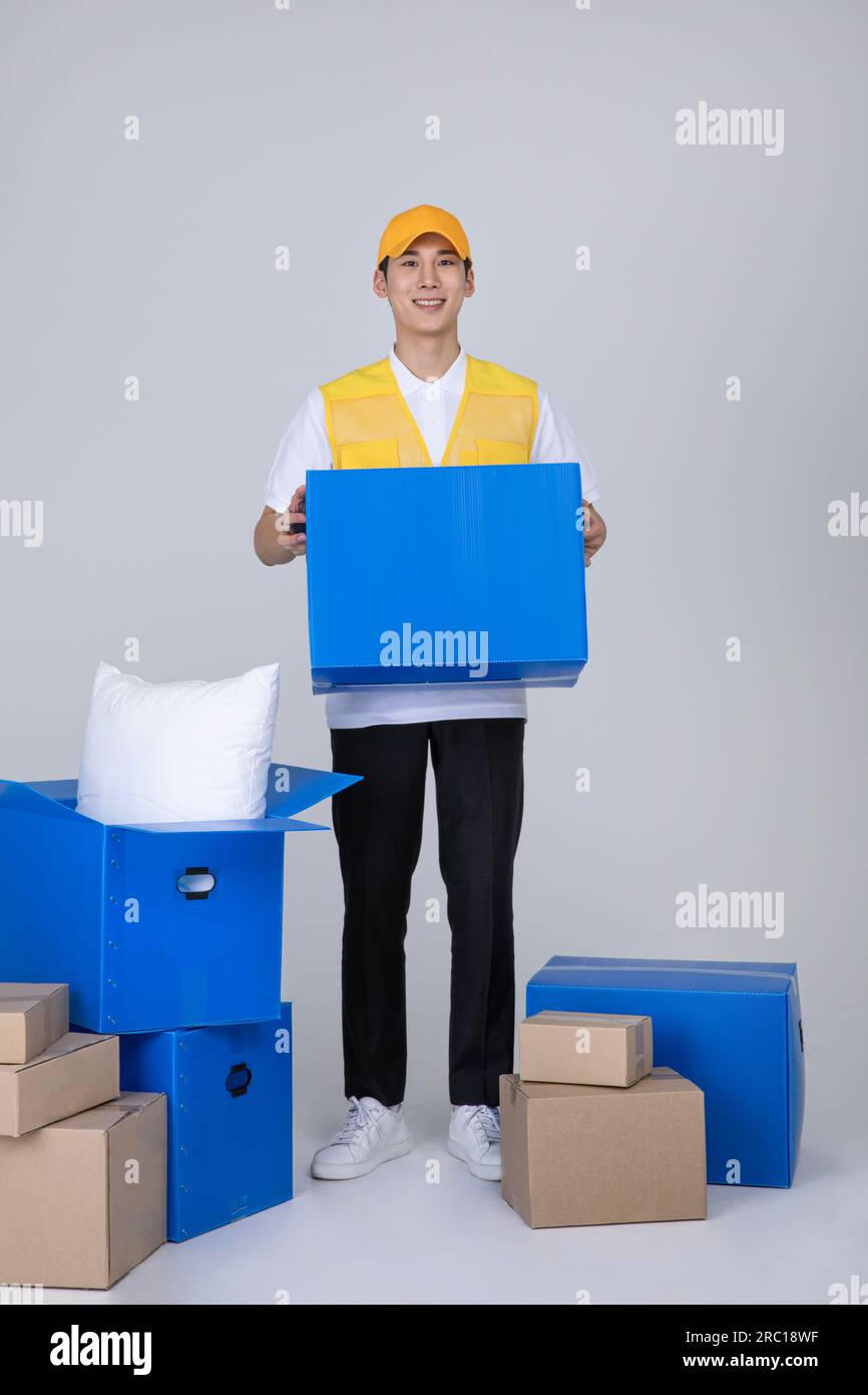 millennials and gen z, korean asian young man organizing moving boxes ...