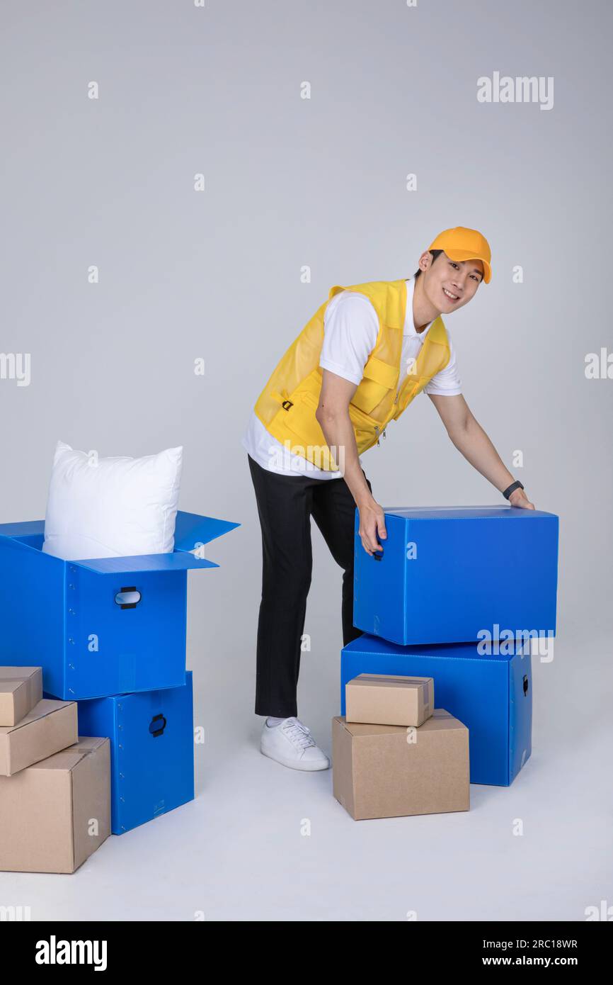 millennials and gen z, korean asian young man organizing moving boxes ...
