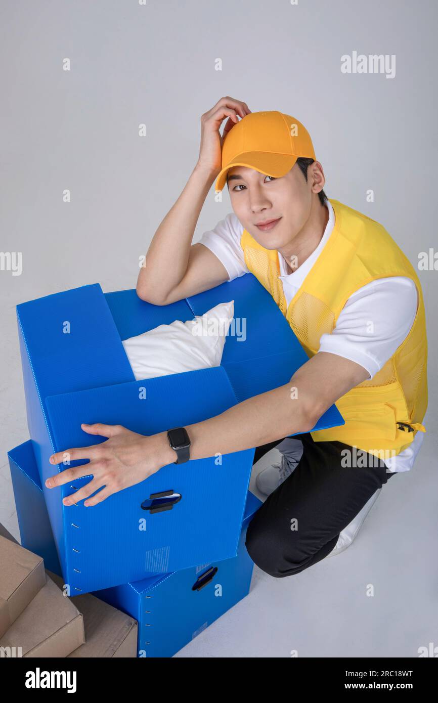 millennials and gen z, korean asian young man organizing moving boxes ...