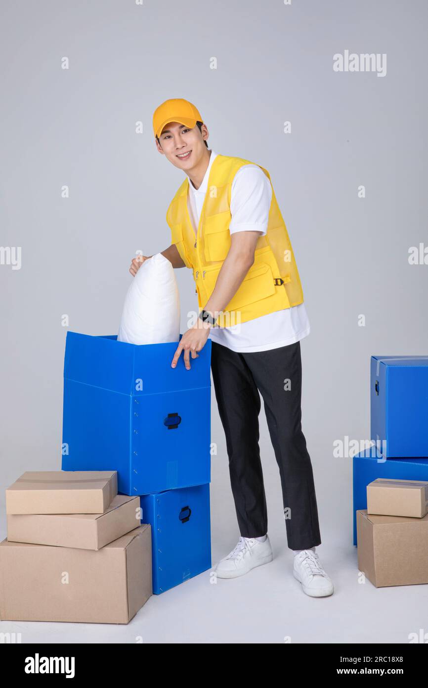 millennials and gen z, korean asian young man organizing moving boxes ...