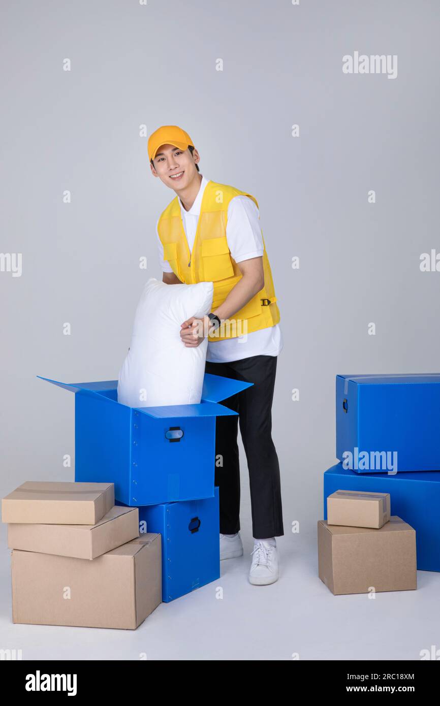 millennials and gen z, korean asian young man organizing moving boxes ...