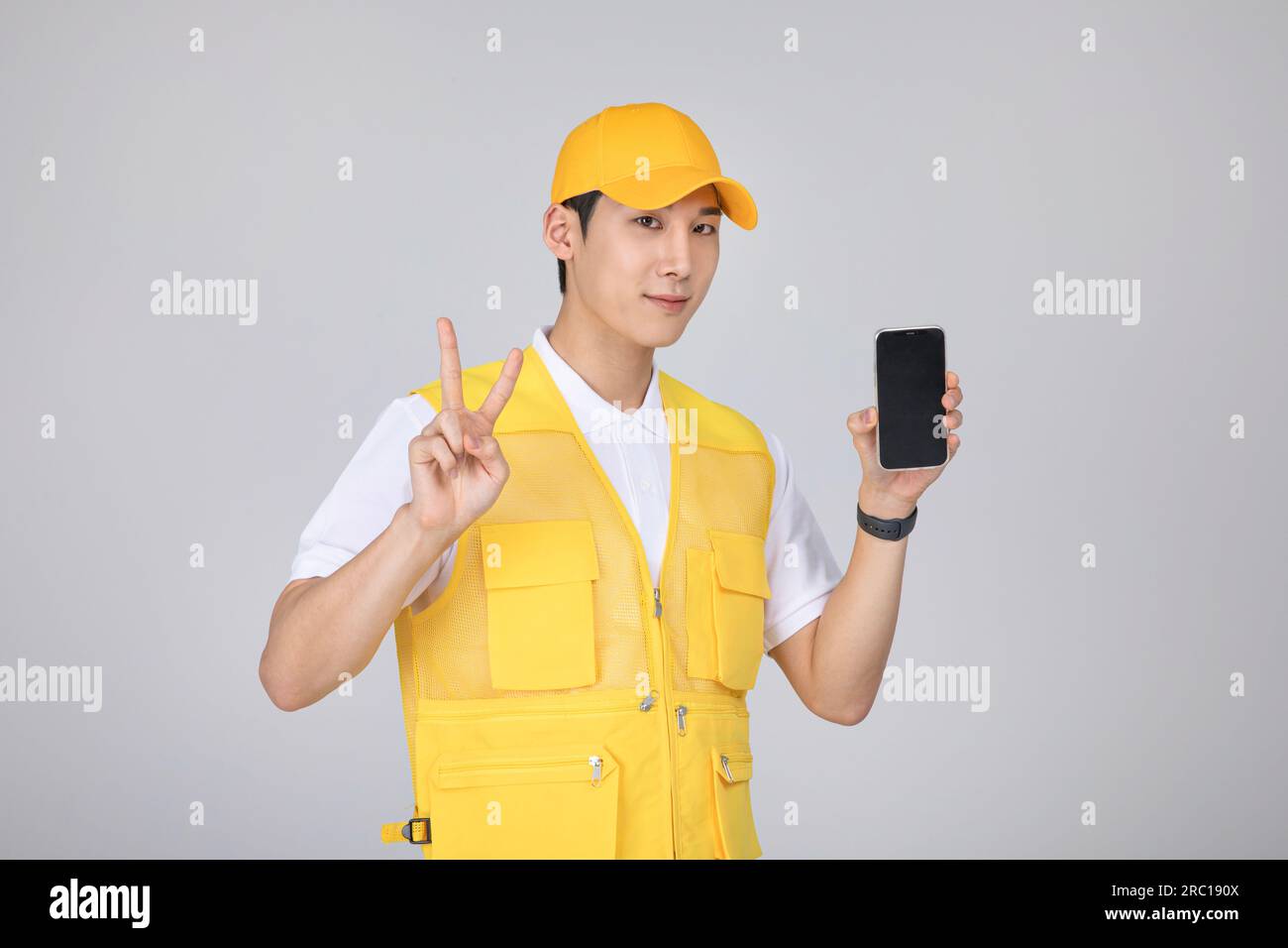 millennials and gen z, korean asian young man holding a smartphone with ...