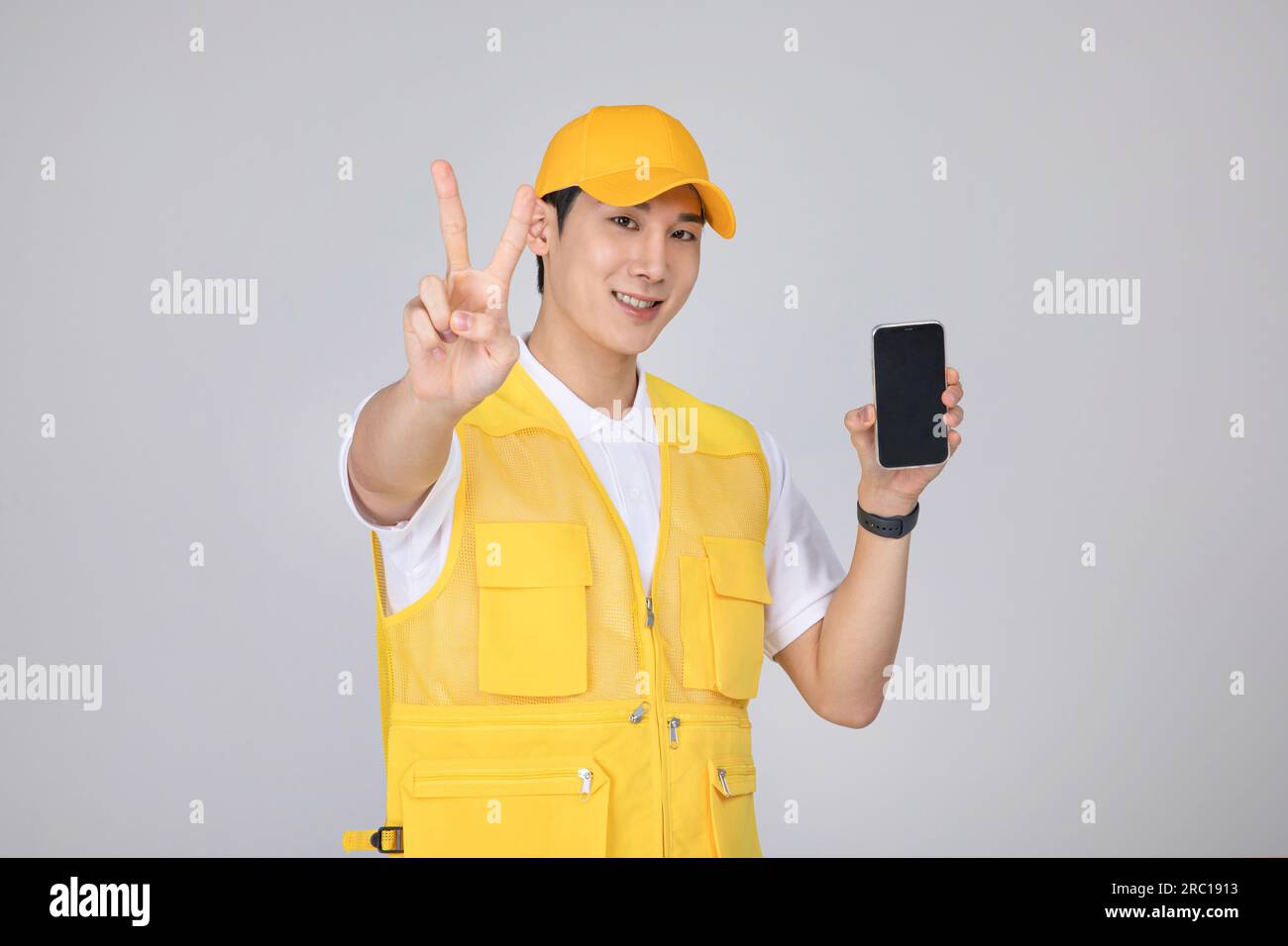 millennials and gen z, korean asian young man holding a smartphone with ...