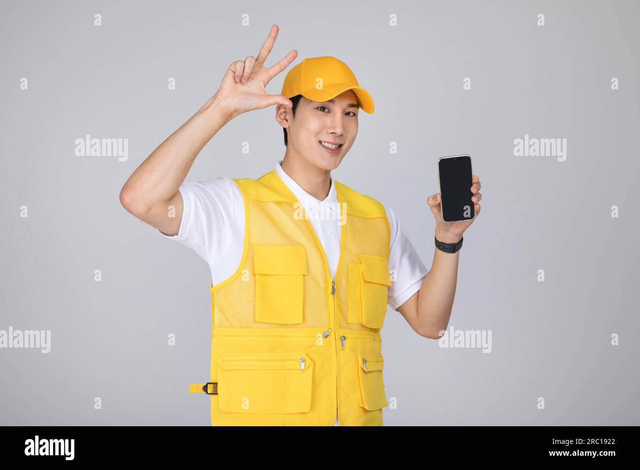 millennials and gen z, korean asian young man holding a smartphone with ...