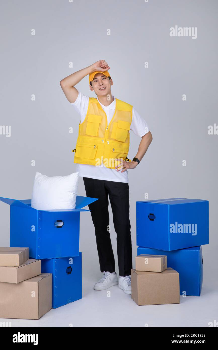 millennials and gen z, korean asian young man organizing moving boxes ...