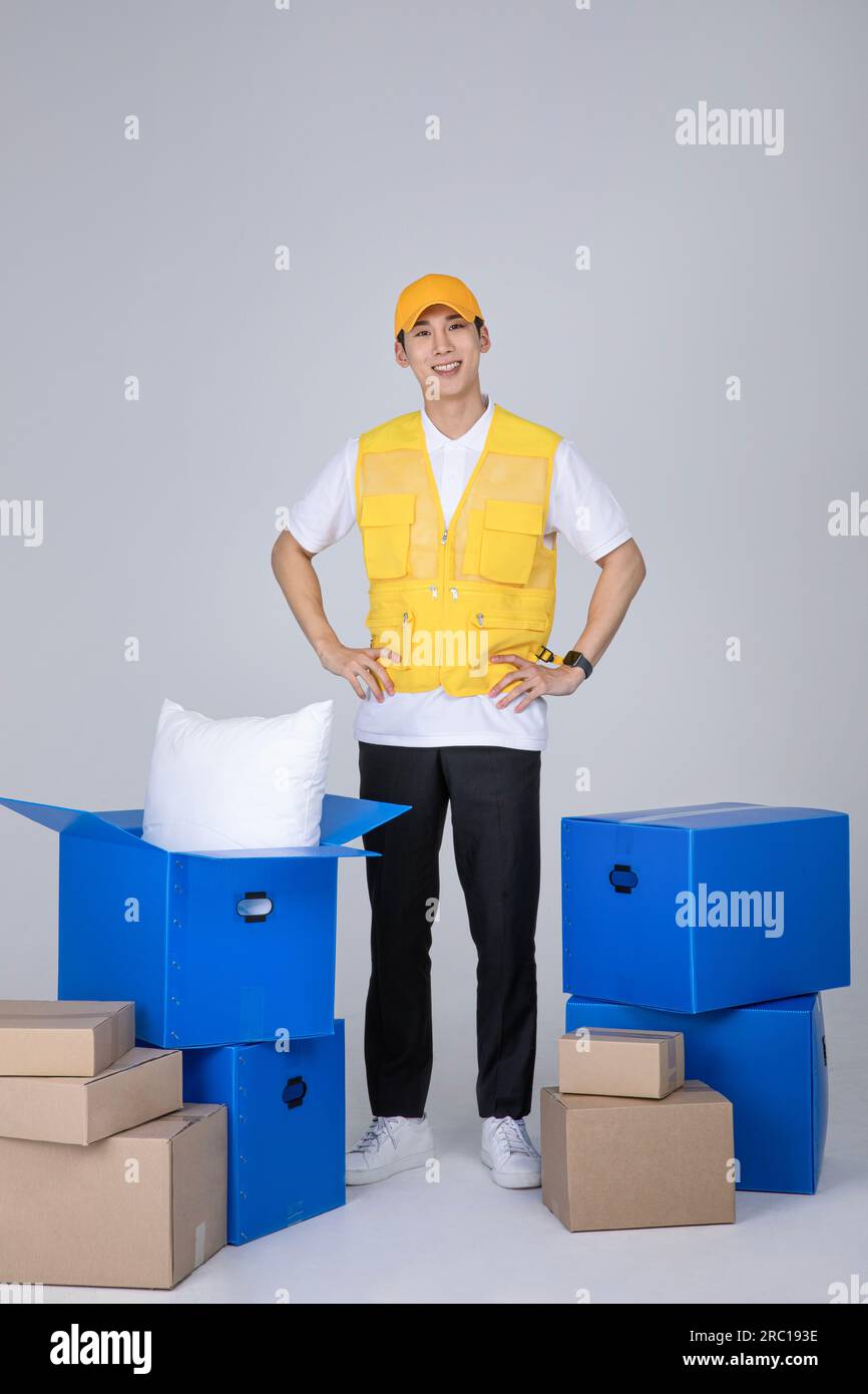 millennials and gen z, korean asian young man organizing moving boxes ...