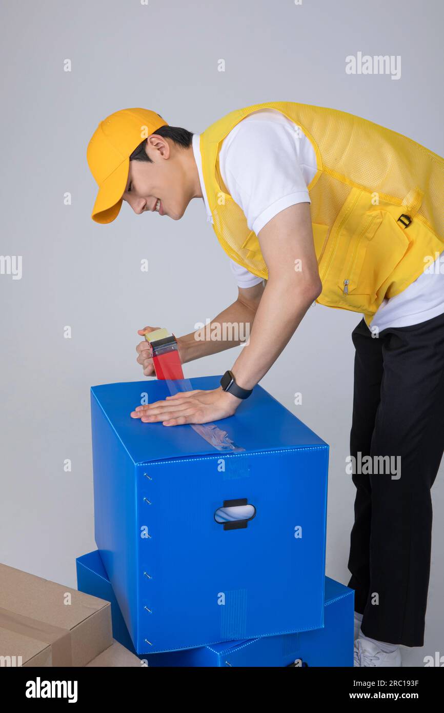 millennials and gen z, korean asian young man organizing moving boxes ...