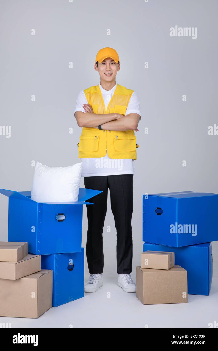 millennials and gen z, korean asian young man organizing moving boxes ...