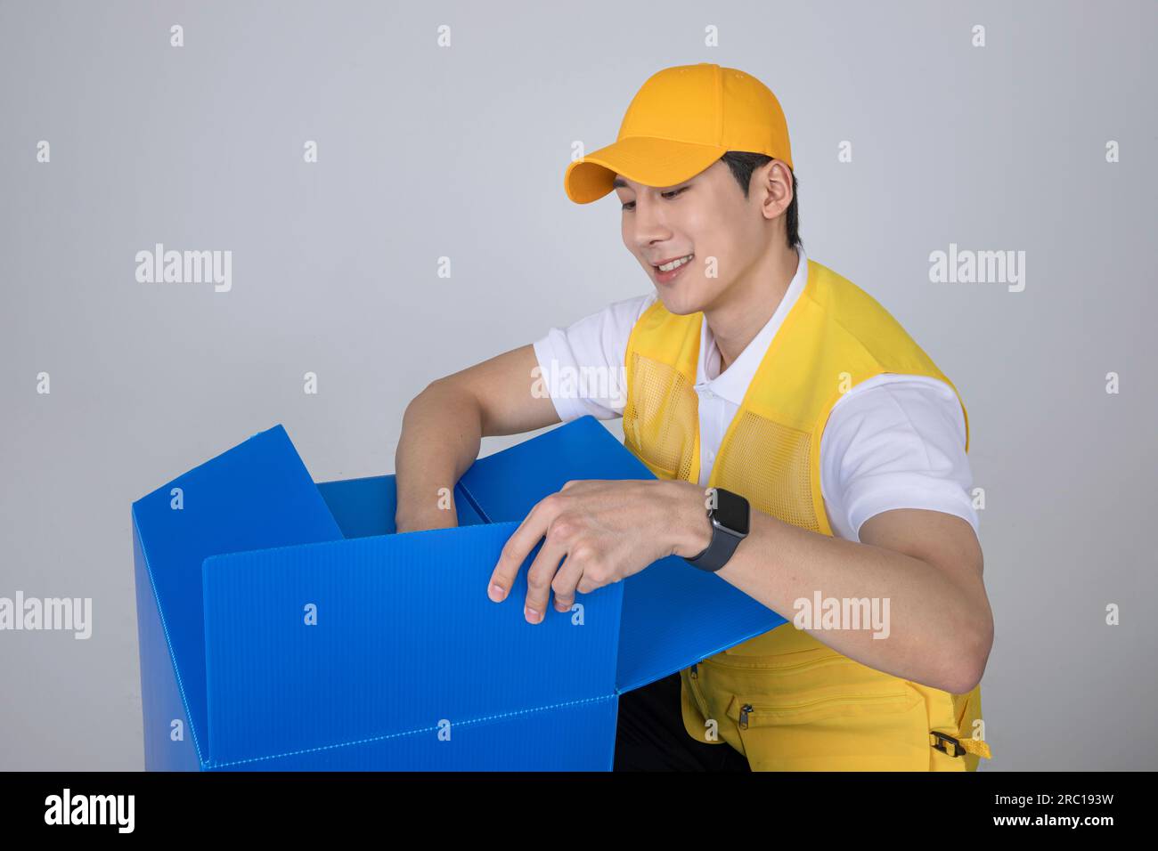 millennials and gen z, korean asian young man organizing moving boxes ...