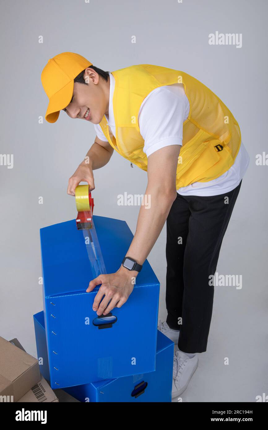 millennials and gen z, korean asian young man organizing moving boxes ...