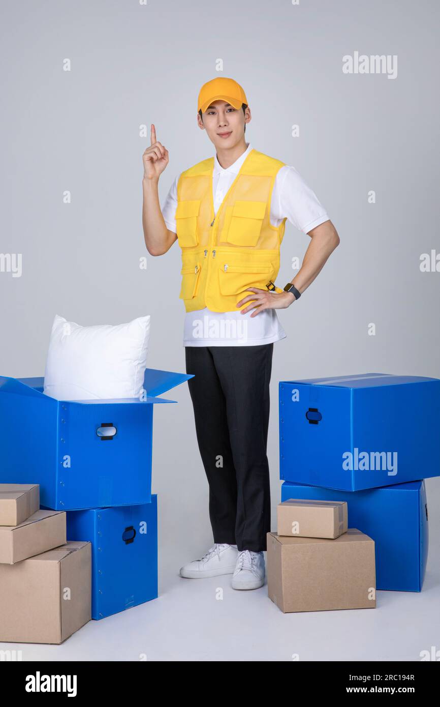 millennials and gen z, korean asian young man organizing moving boxes ...