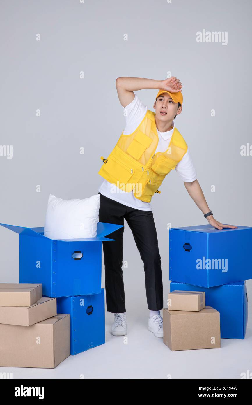 millennials and gen z, korean asian young man organizing moving boxes ...