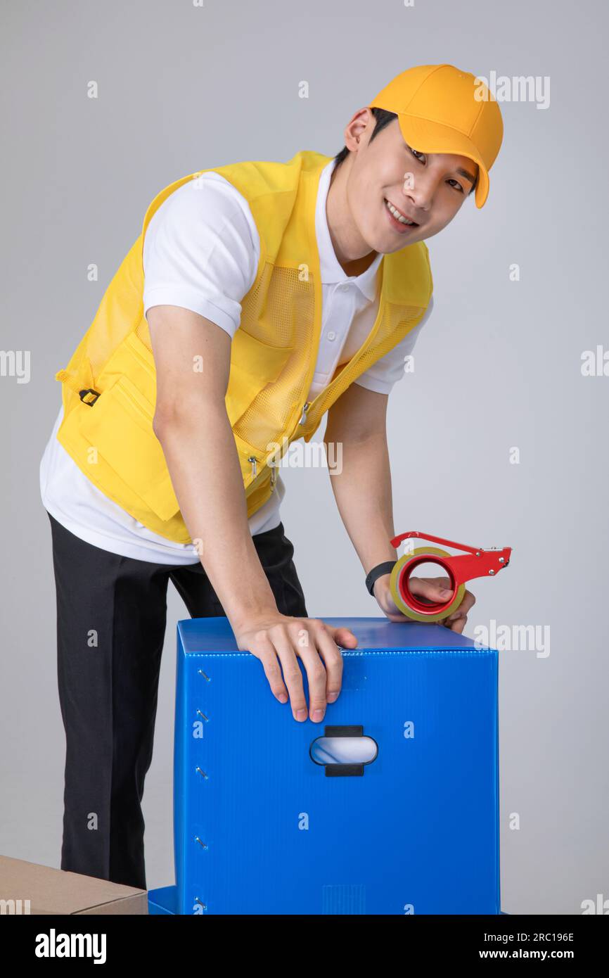 millennials and gen z, korean asian young man organizing moving boxes ...