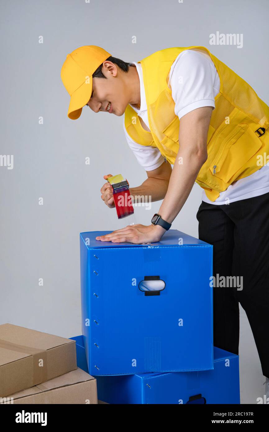 millennials and gen z, korean asian young man organizing moving boxes ...