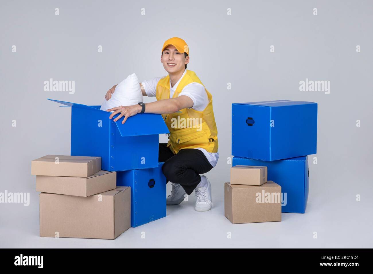 millennials and gen z, korean asian young man organizing moving boxes ...