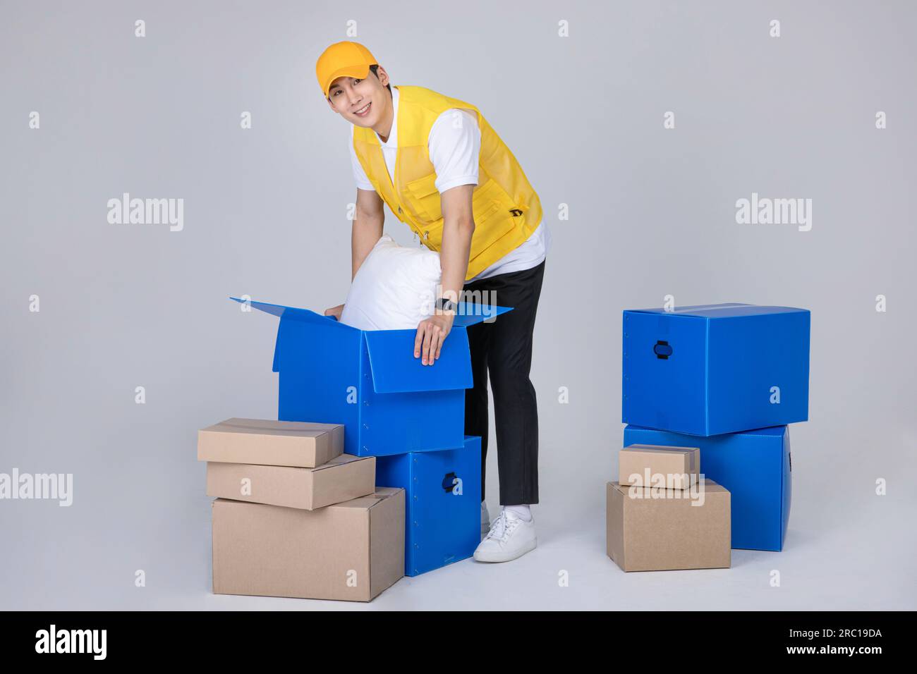 millennials and gen z, korean asian young man organizing moving boxes ...