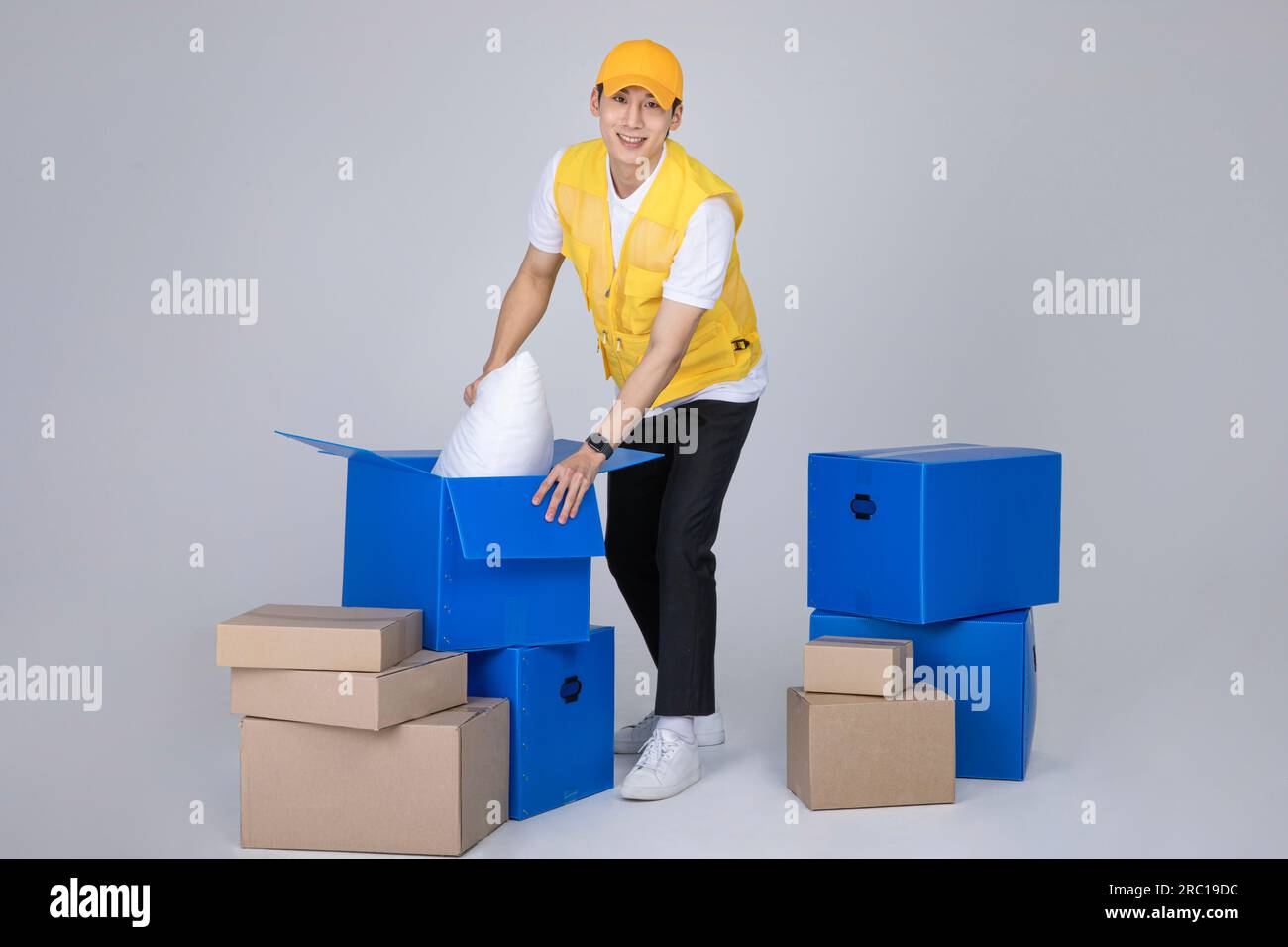 millennials and gen z, korean asian young man organizing moving boxes ...
