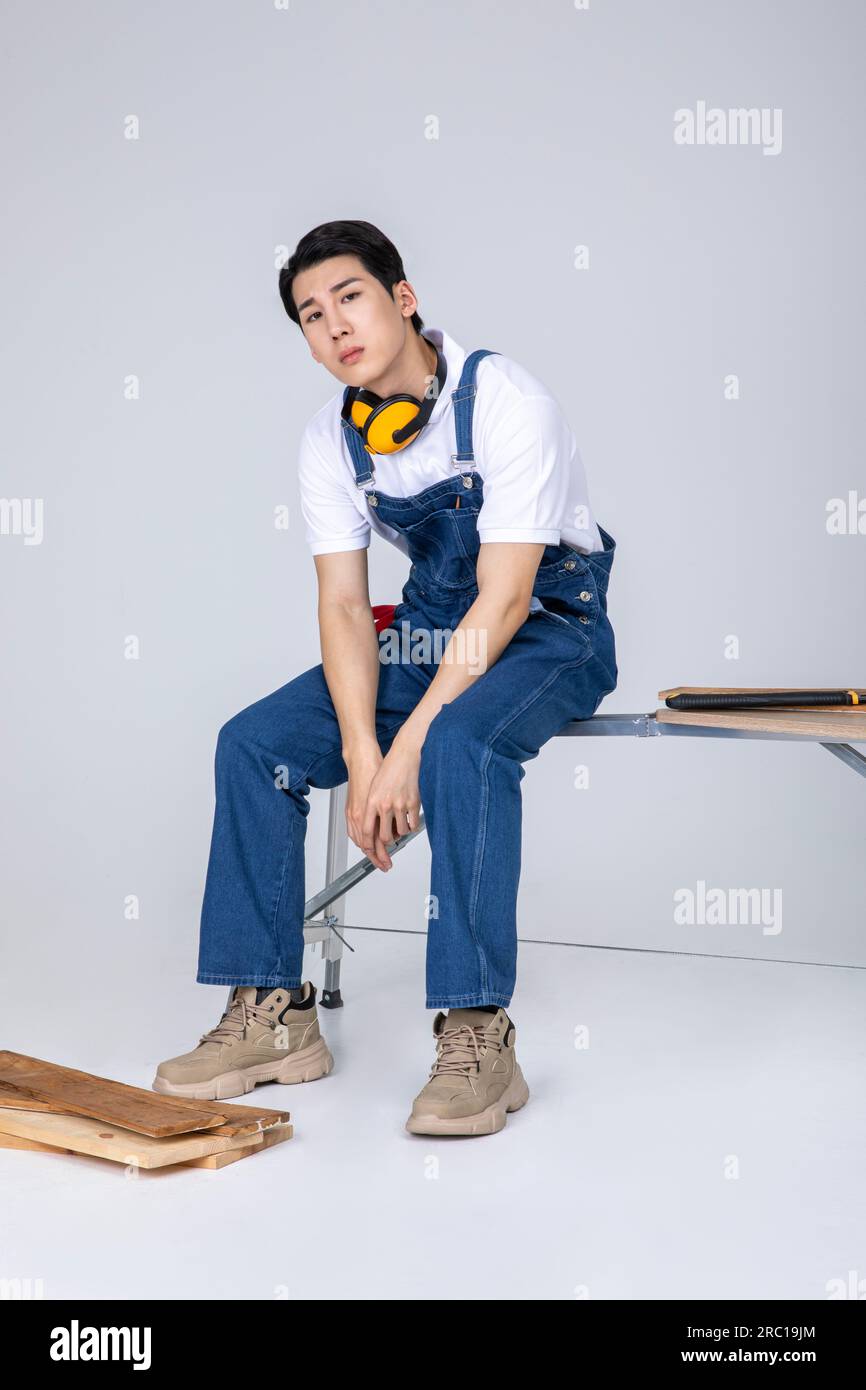 millennials and gen z, korean asian young man carpenter sitting and ...