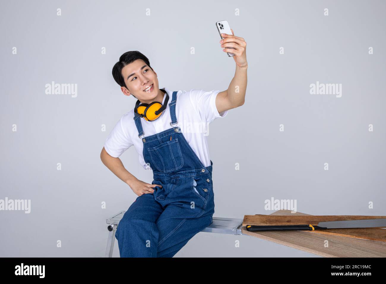 millennials and gen z, korean asian young man carpenter taking selfie ...