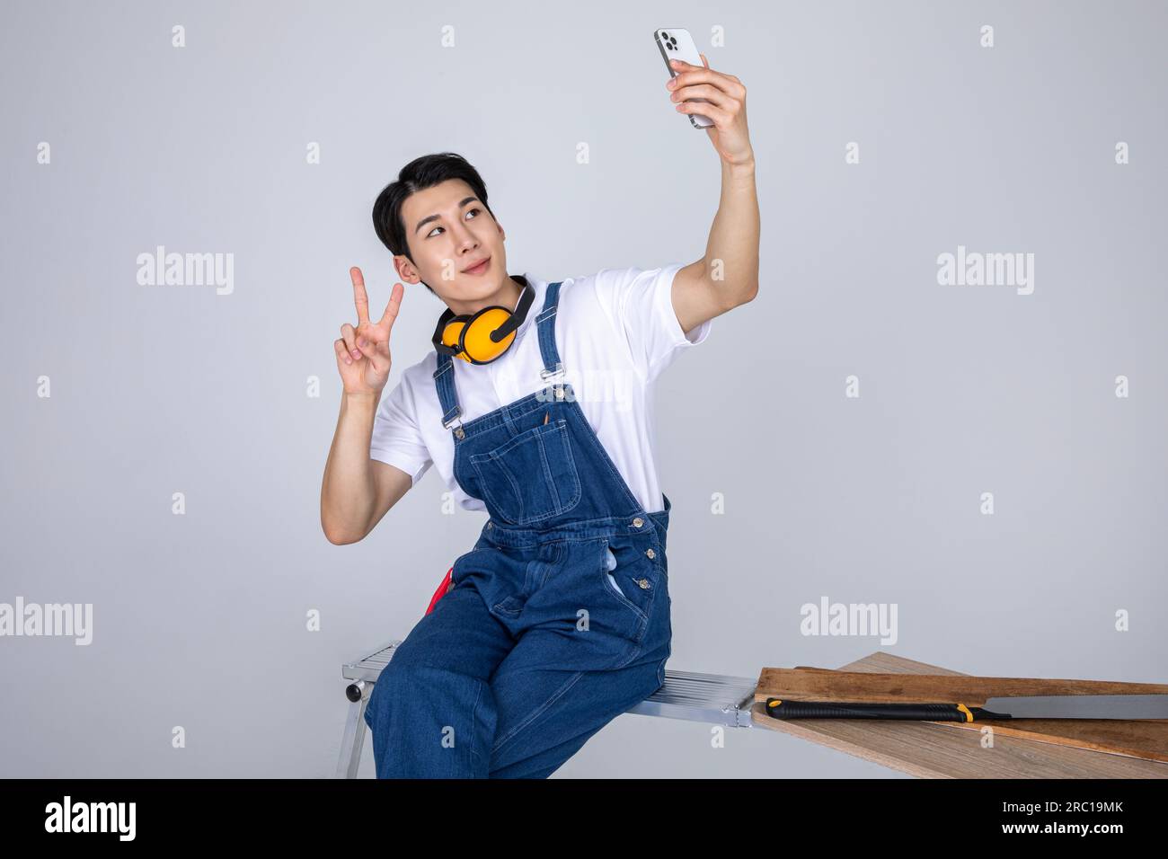 millennials and gen z, korean asian young man carpenter taking selfie ...