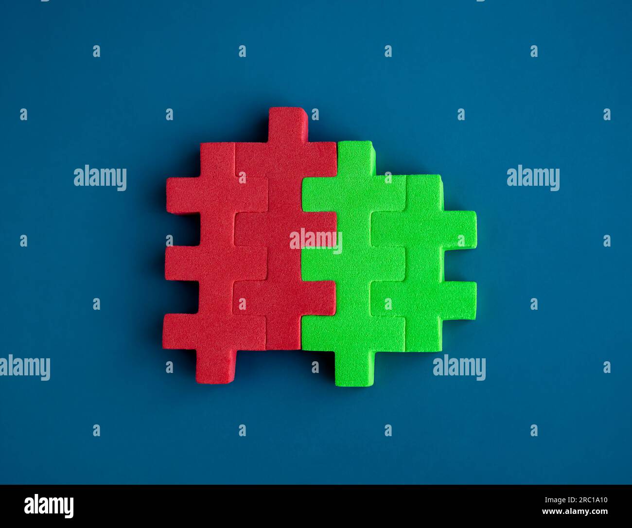 Red and green puzzle blocks are perfectly put together on blue ...
