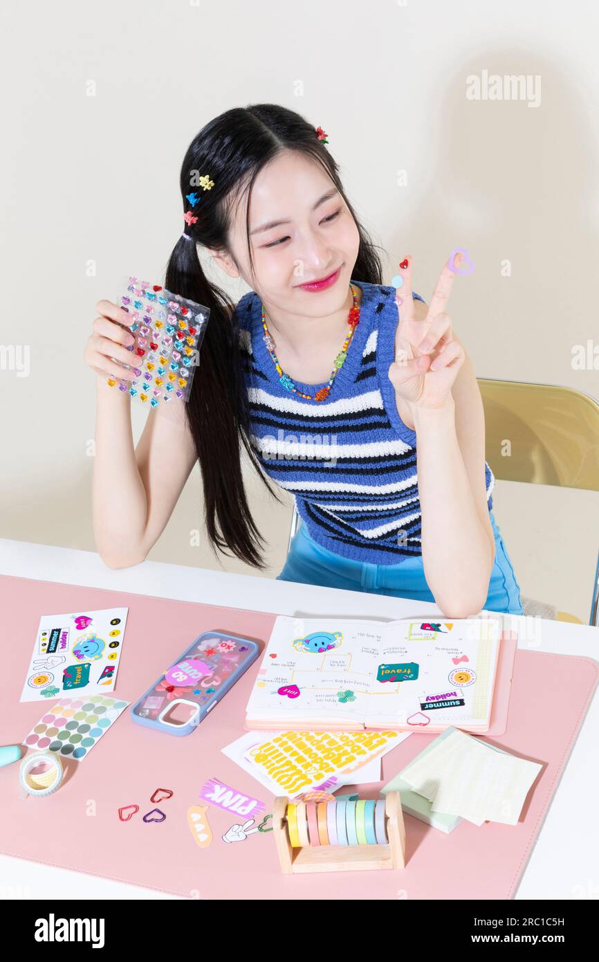 vintage y2k retro concept photo of korean asian cute woman decorating a ...