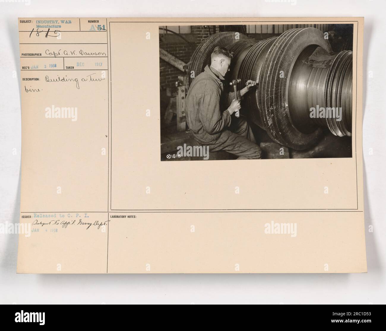 The image shows a group of workers in December 1917 engaged in the ...