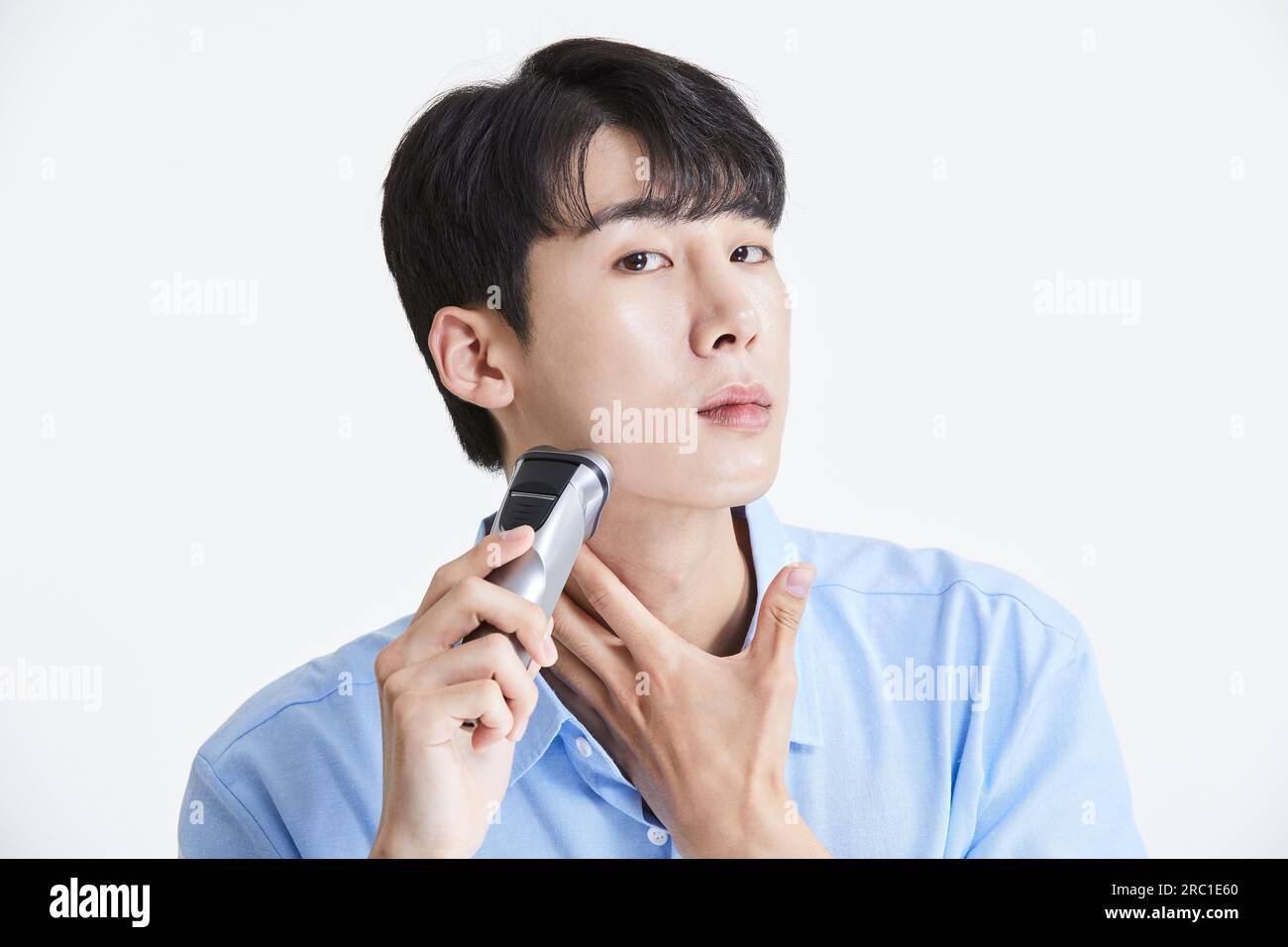 korean asian young man shaving his chin Stock Photo - Alamy