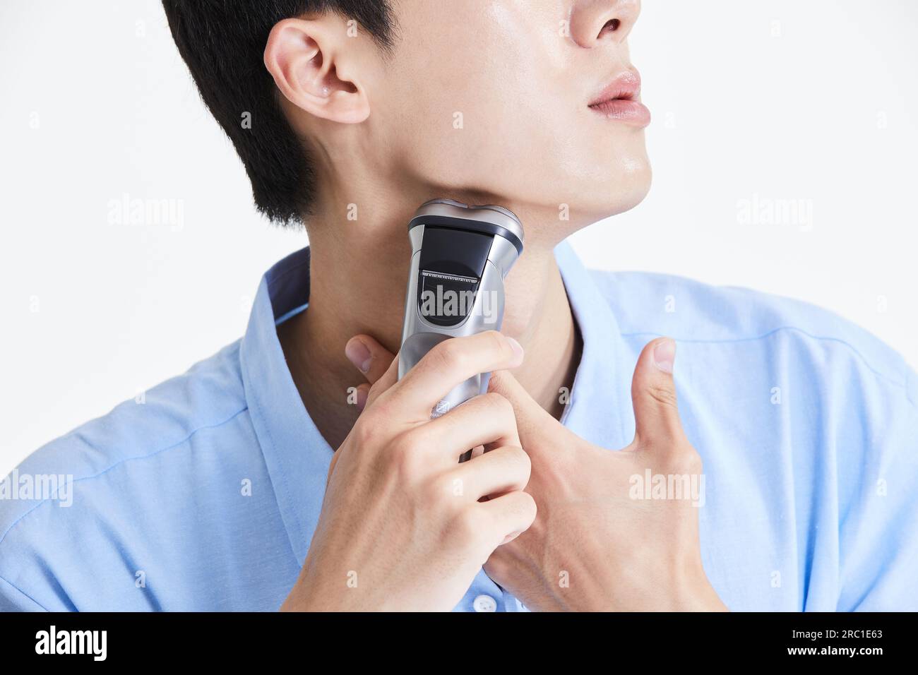korean asian young man shaving his chin Stock Photo - Alamy