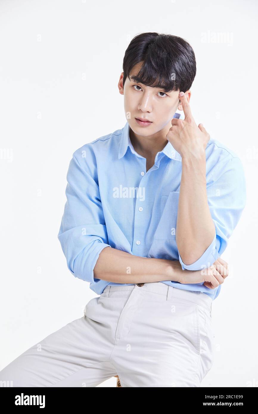 korean asian young man sitting on stool Stock Photo - Alamy