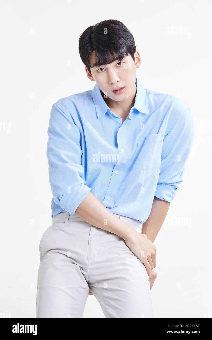 korean asian young man sitting on stool Stock Photo - Alamy