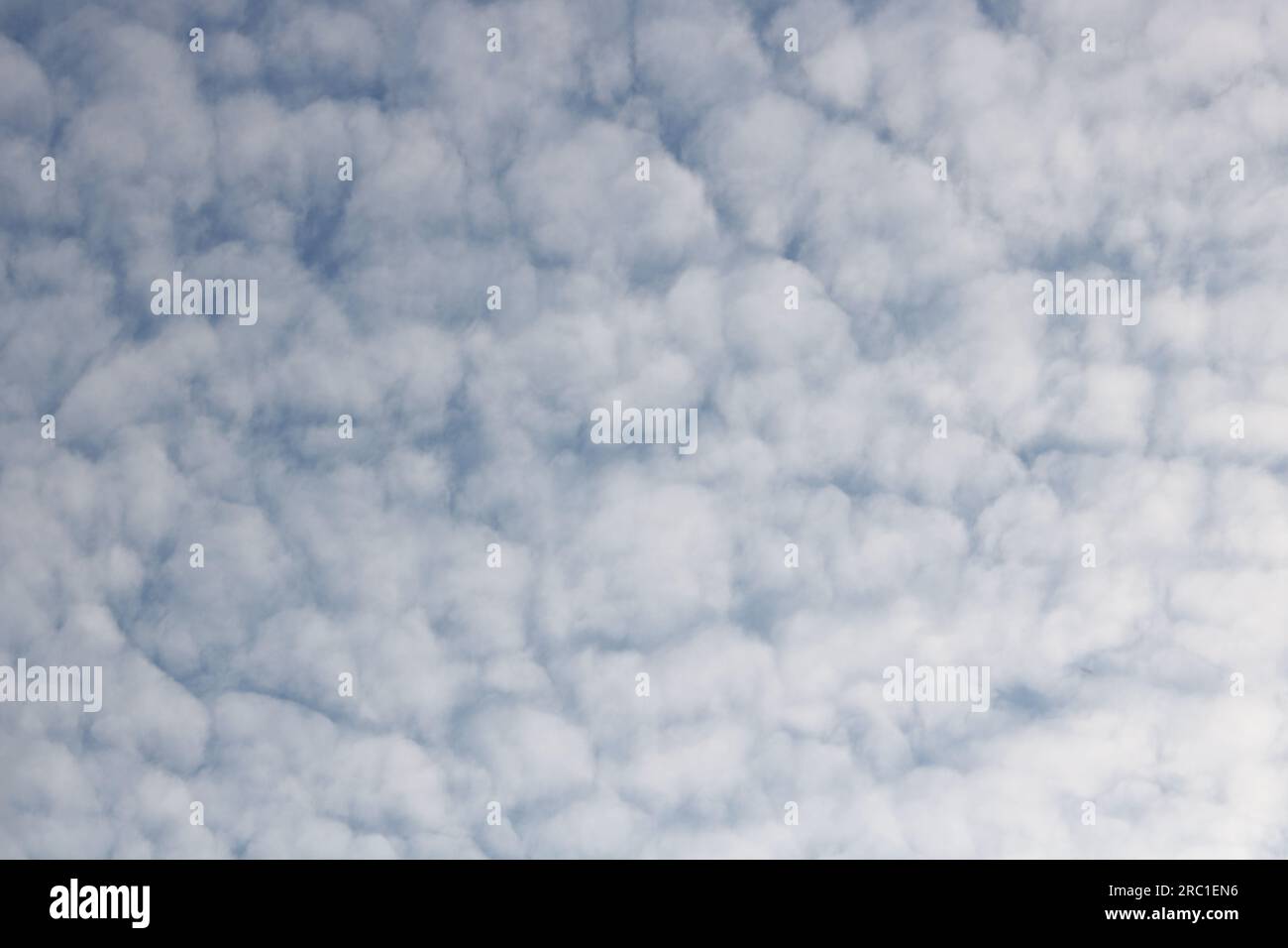 Full frame of pretty blue sky with unusual scudding cloud formation ...