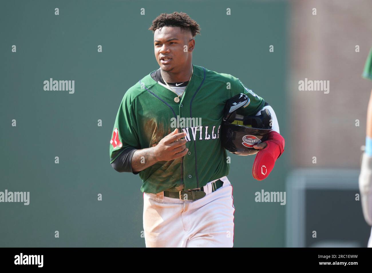 Right fielder Bryan Gonzalez (15) of the Greenville Drive heads back to ...