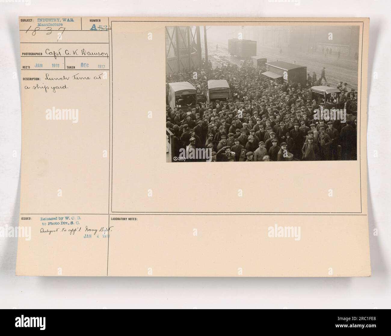 Workers take their lunch break at a shipyard during World War One. The ...