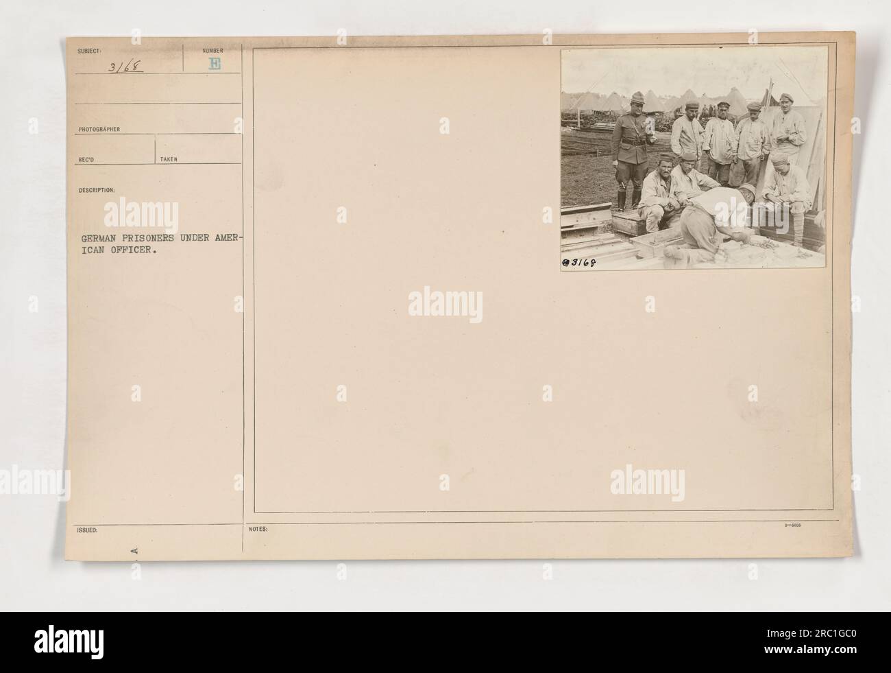 German prisoners of war being guarded by an American officer during ...