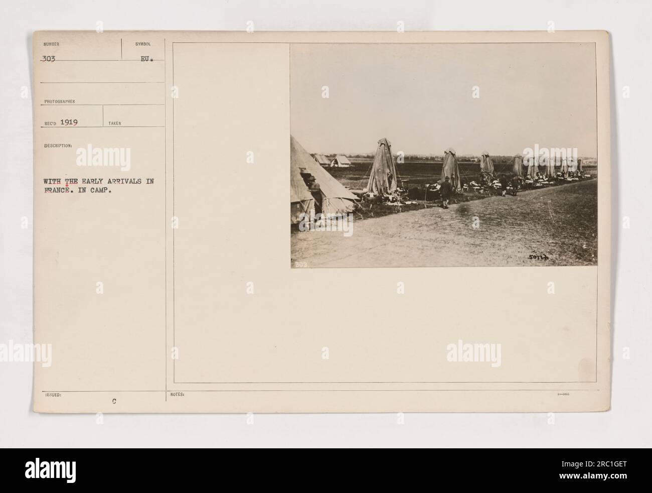 Soldiers look on as supplies are unloaded from a truck upon their early ...