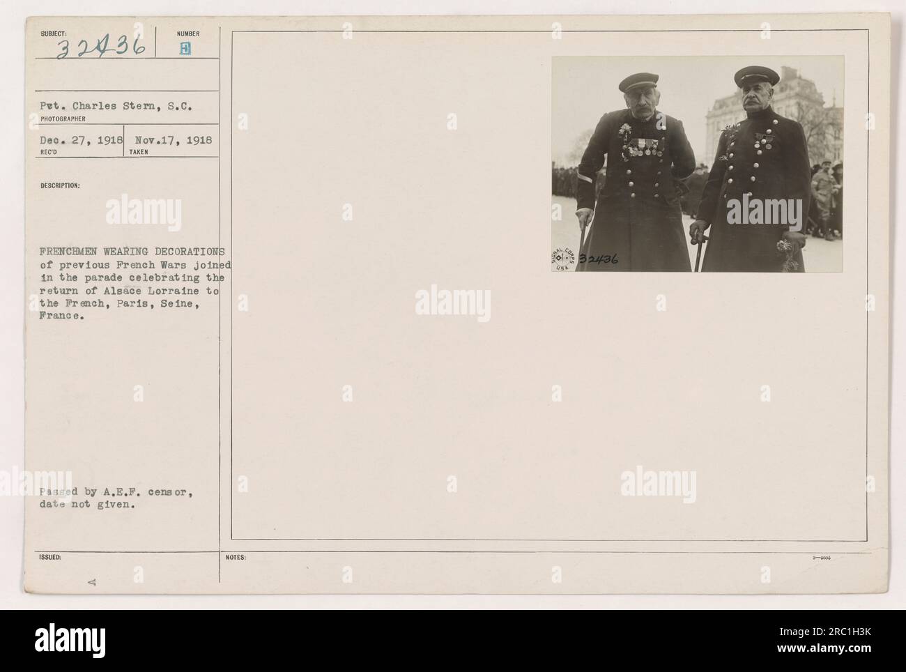 French civilians wearing military decorations participate in a parade ...