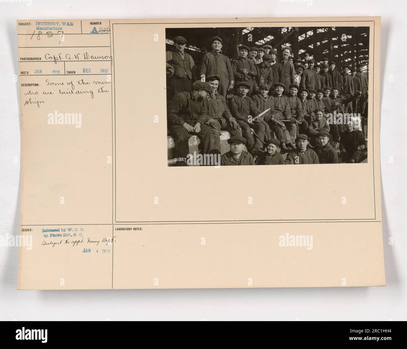 Men work diligently to construct ships for the war effort during World ...